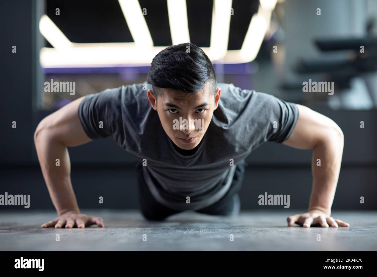 Young Chinese man exercising at gym Stock Photo - Alamy