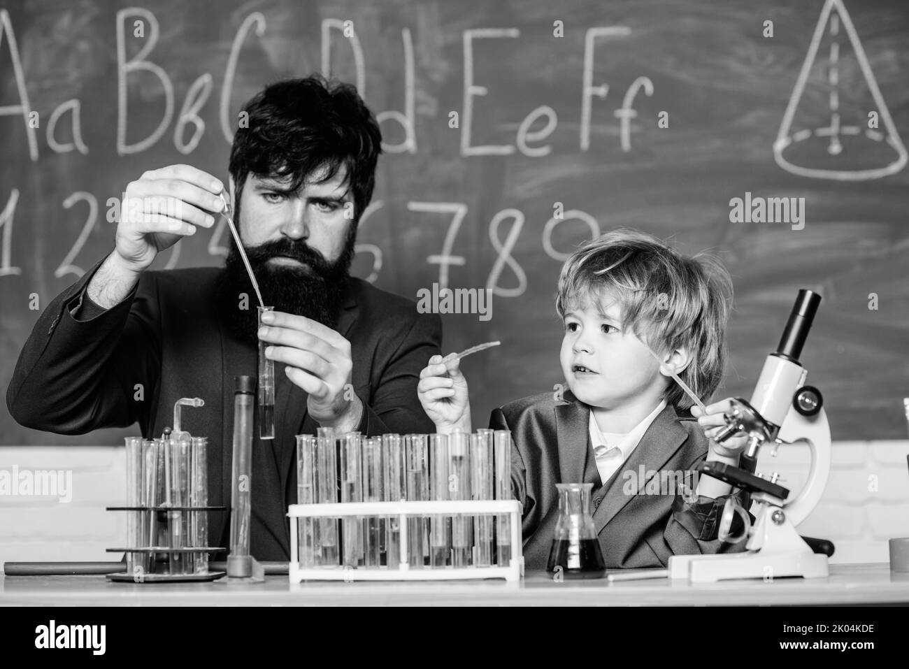 father and son at school. Back to school. learning chemistry in school ...