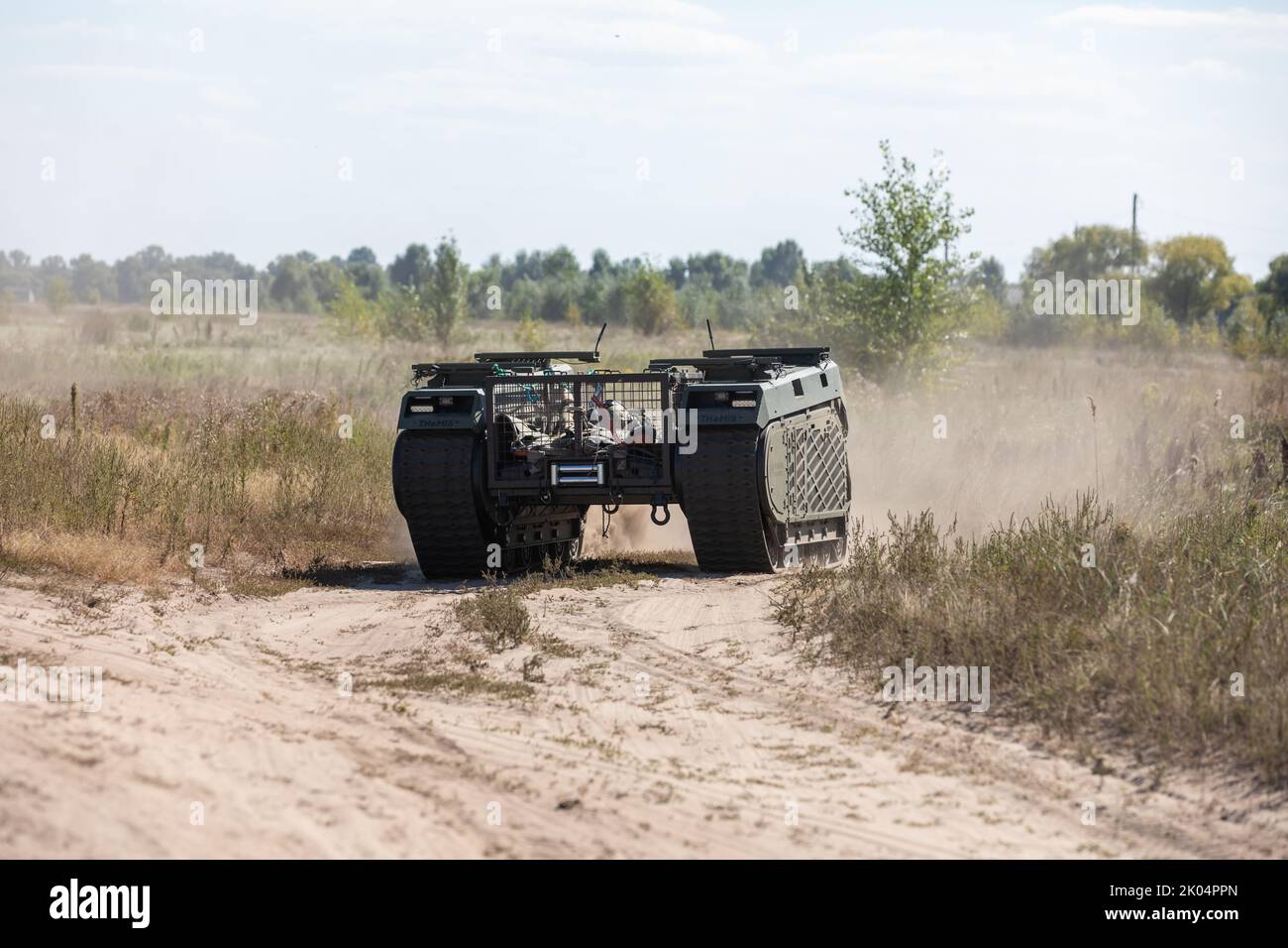 A THeMIS multi-purpose tracked drone is seen on a dusty road while ...
