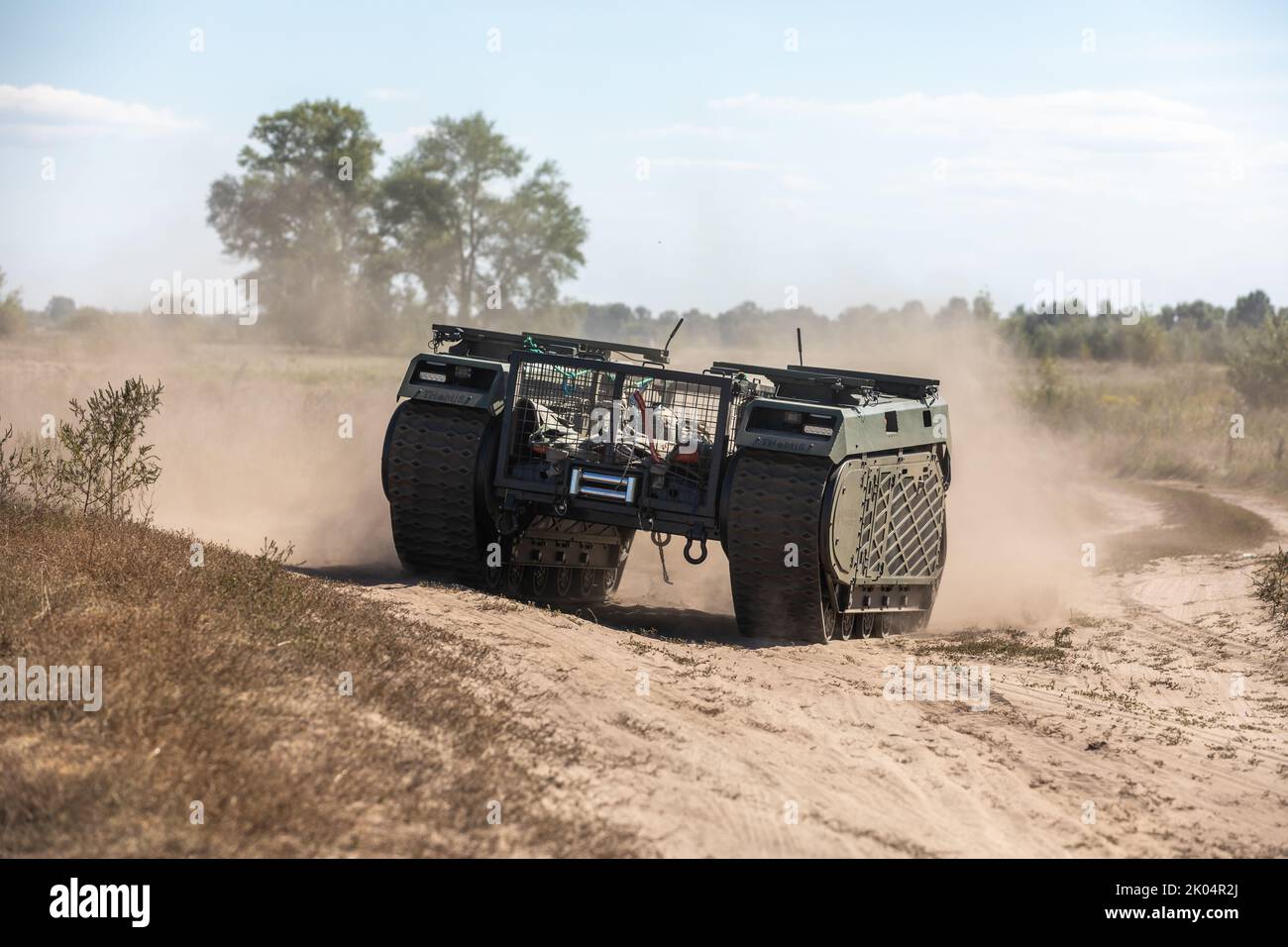 A THeMIS multi-purpose tracked drone is seen on a dusty road while ...