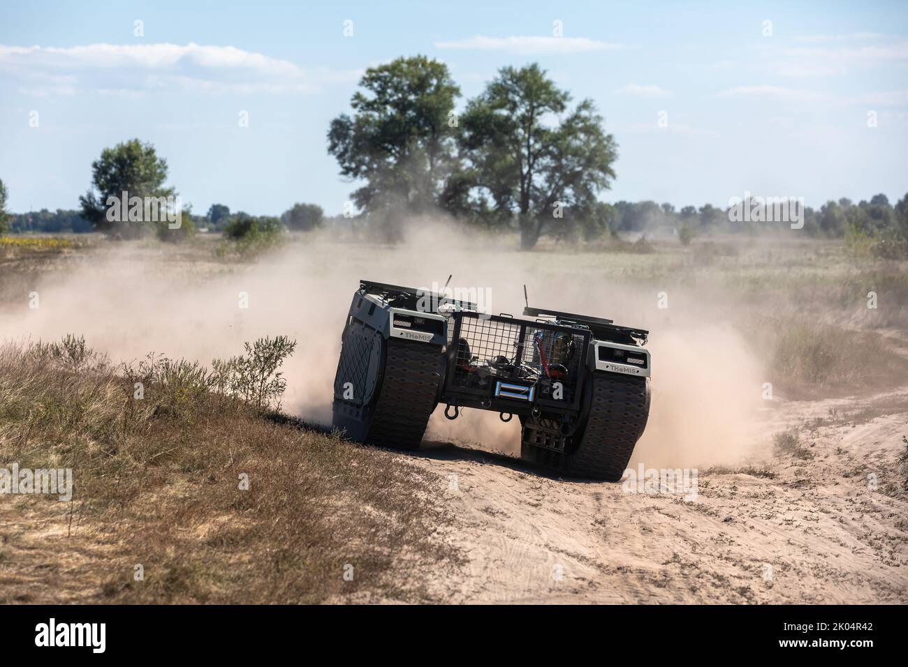 A THeMIS multi-purpose tracked drone is seen on a dusty road while ...