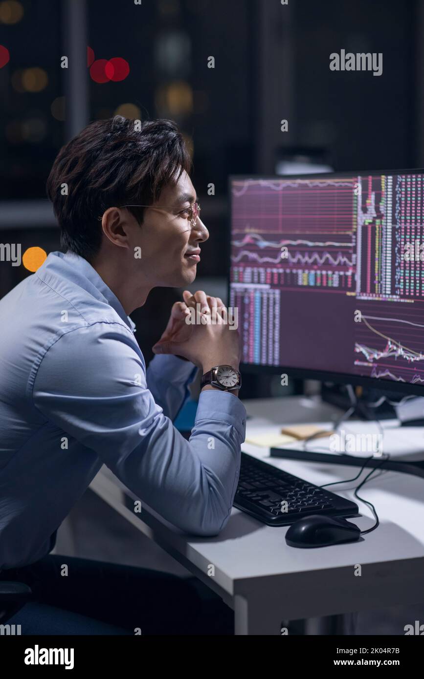Chinese businessman working in office at night Stock Photo - Alamy