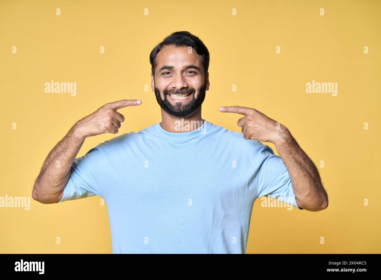 Happy indian man pointing fingers at healthy white teeth isolated on ...