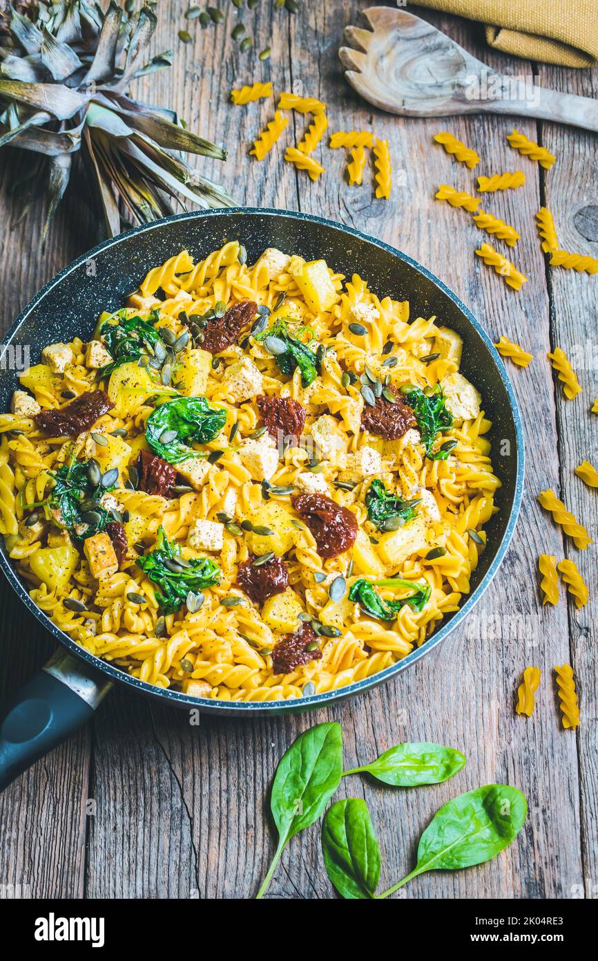 Vegan Italian corn gluten free fusilli pasta with tofu, spinach, dried ...