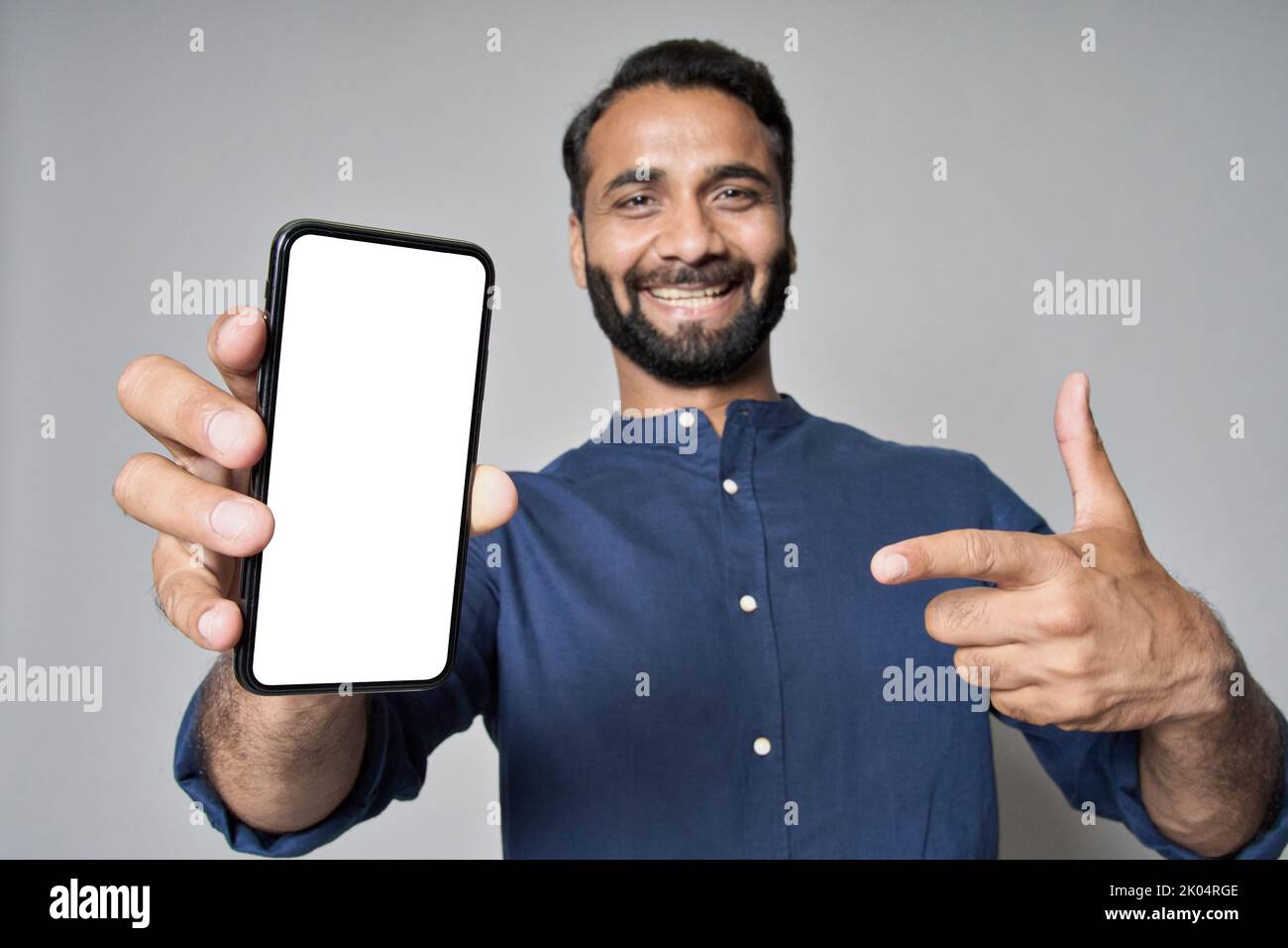 Happy indian business man pointing at mobile phone screen mockup Stock ...