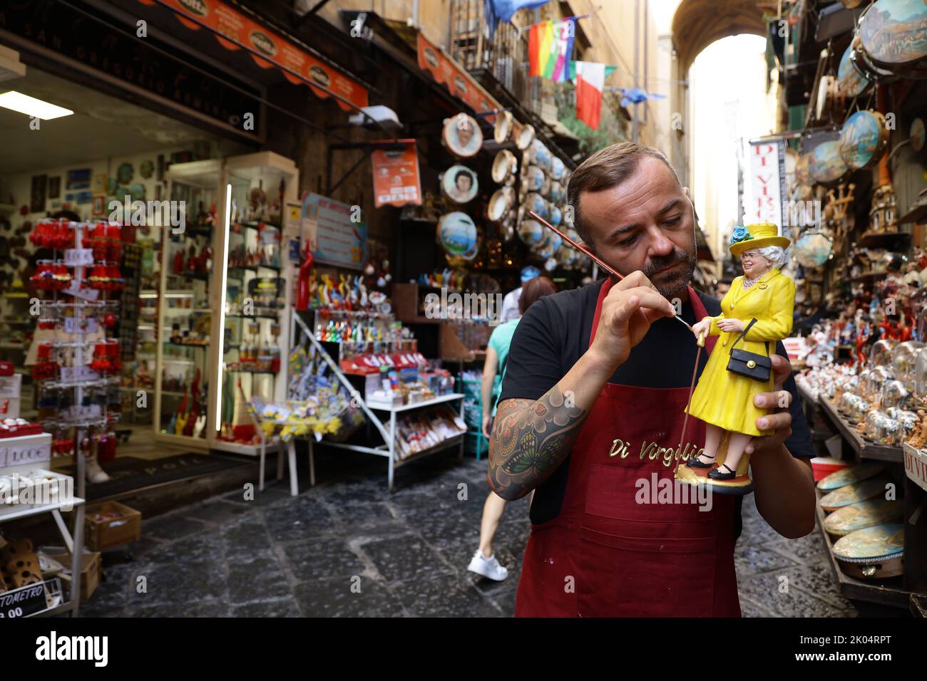 Craftsman Gennaro Di Virgilio works on a figurine depicting Queen ...