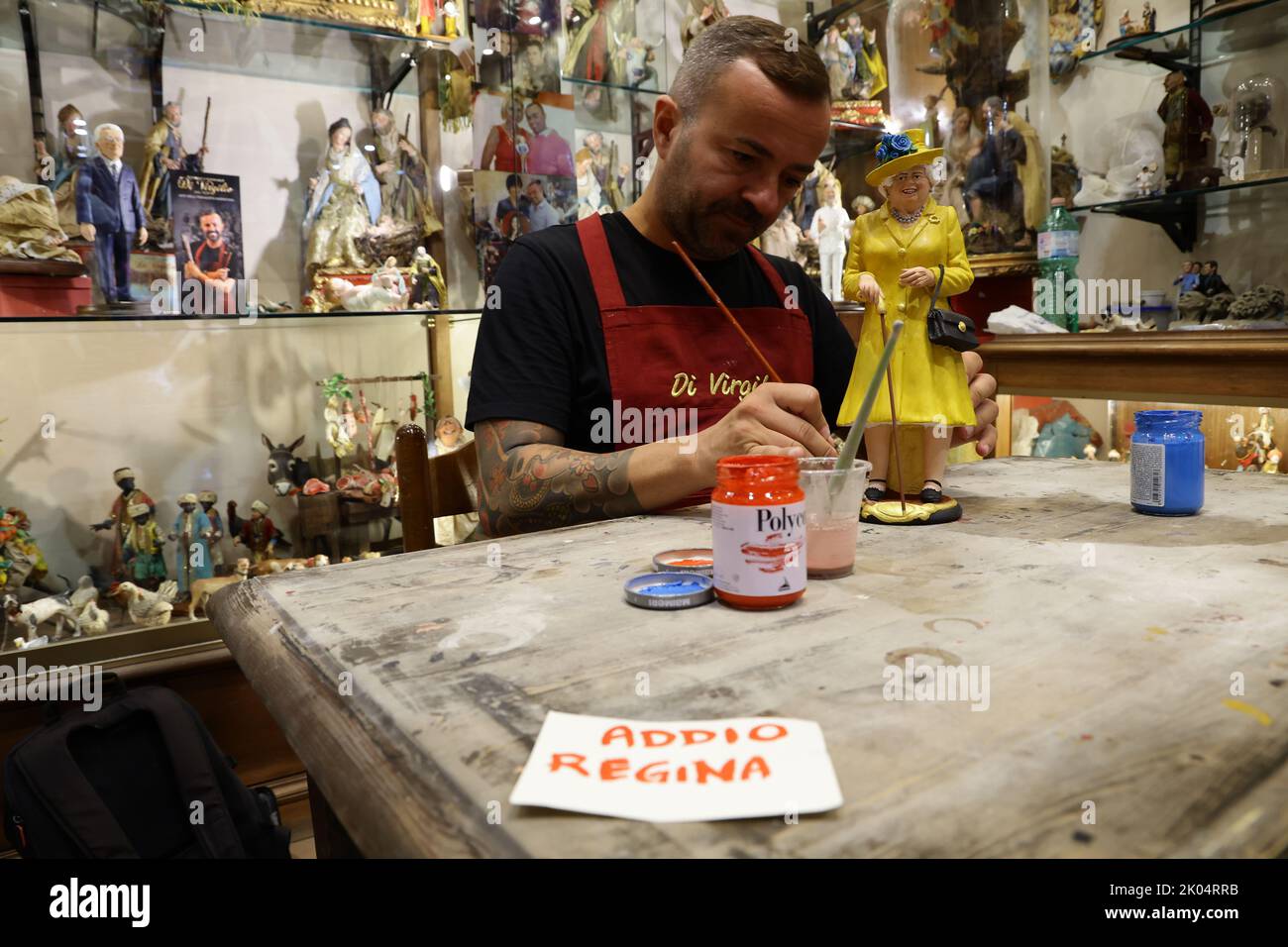 Craftsman Gennaro Di Virgilio works on a figurine depicting Queen ...