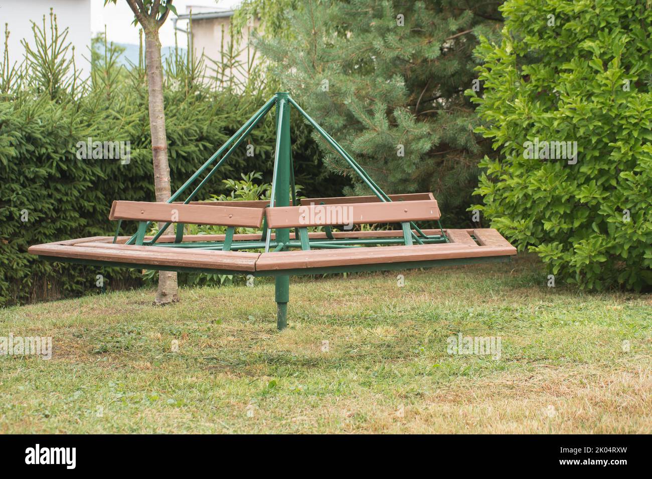 Retro socialist kids carousel made of wood and iron. Children's ...