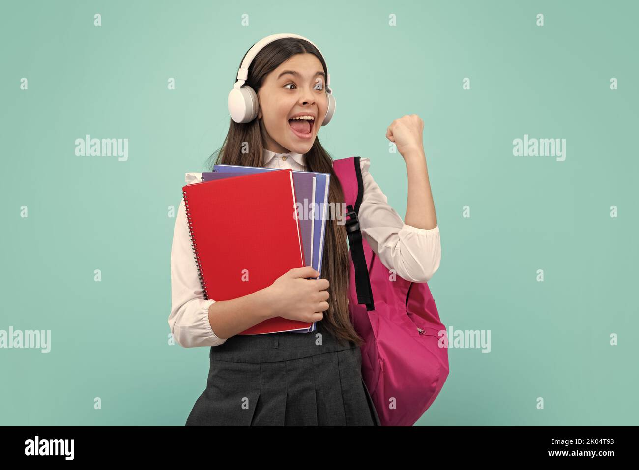 Excited face. School girl, teenage student in headphones and books on ...