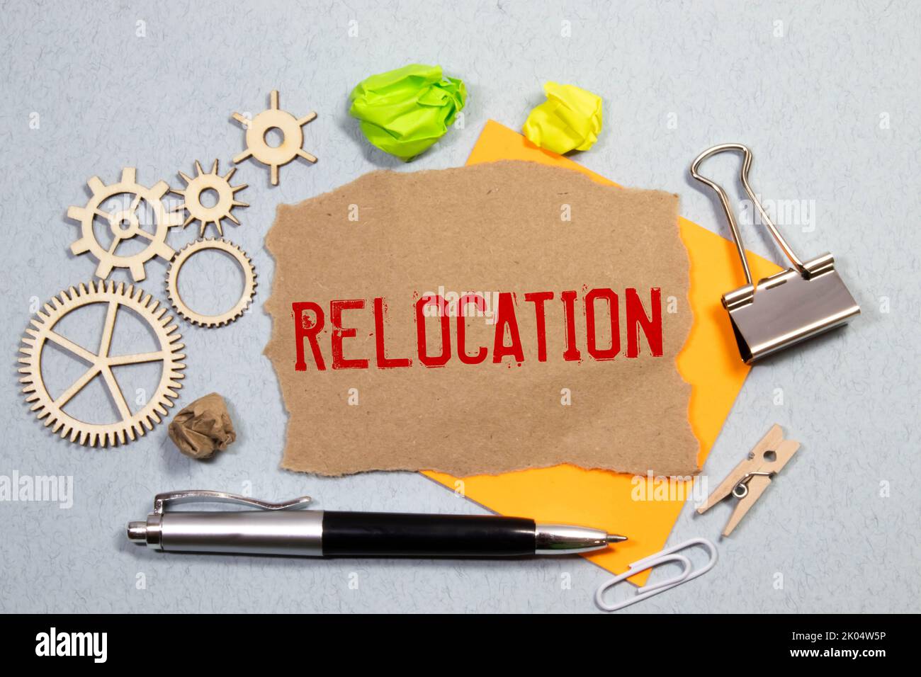 RELOCATE word written on wood block Stock Photo - Alamy