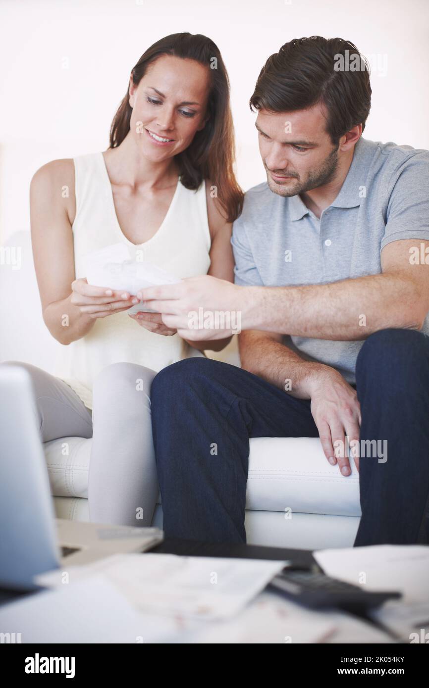 Budgeting- two brains are better than one. A married couple inspecting ...