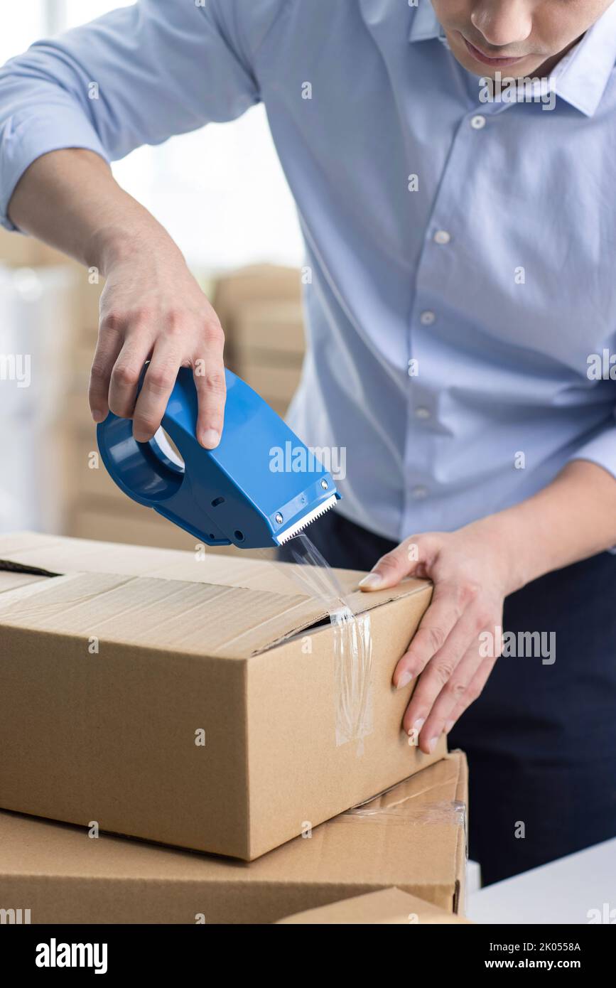 Businessman packing up box in office hi-res stock photography and ...