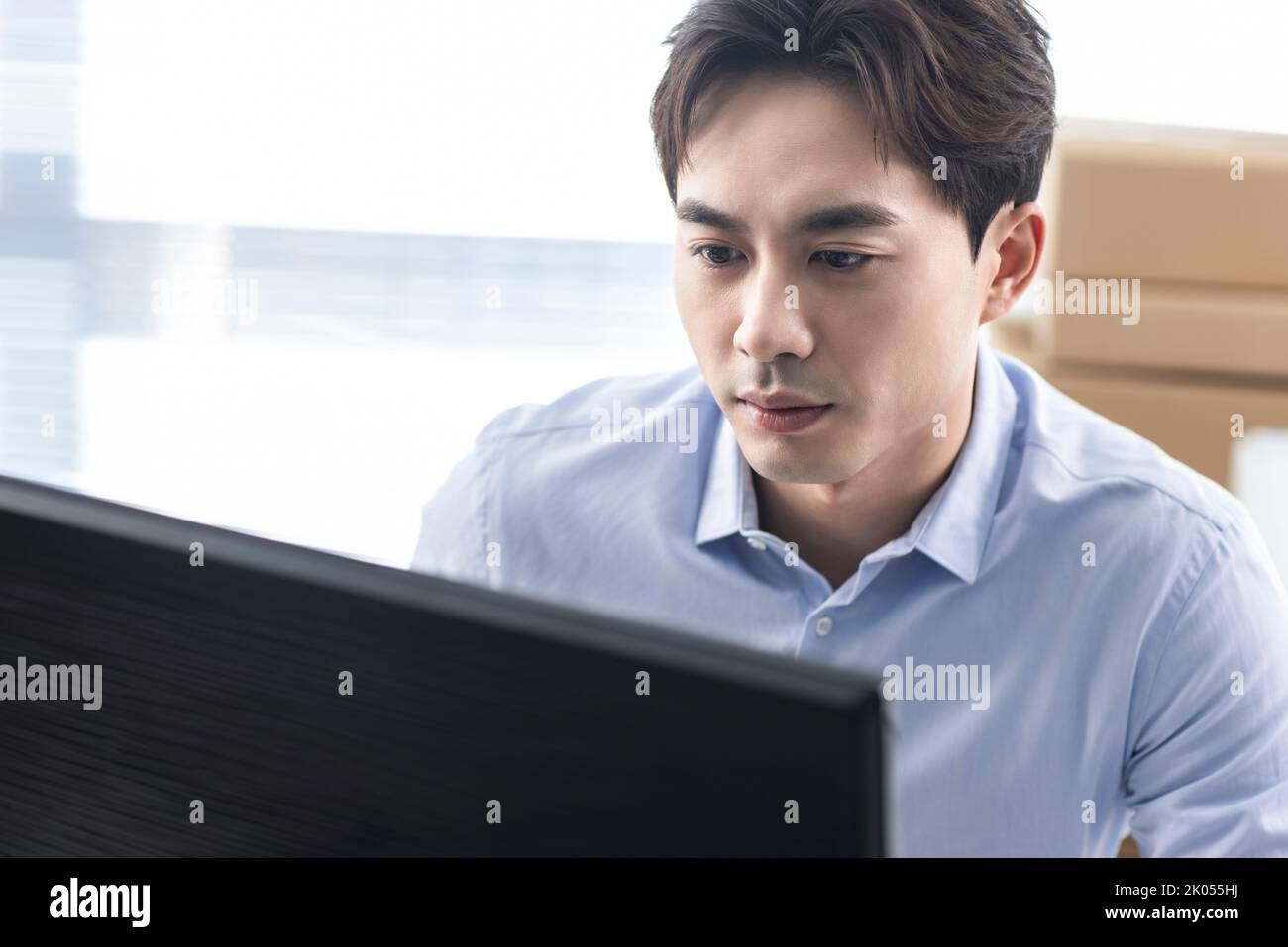 Chinese businessman using computer in office Stock Photo - Alamy