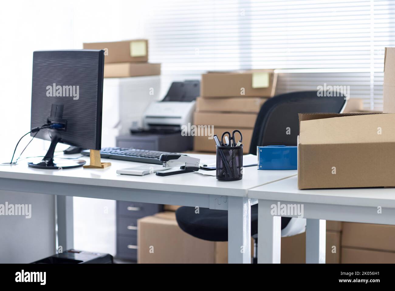 Office table with boxes on it Stock Photo - Alamy