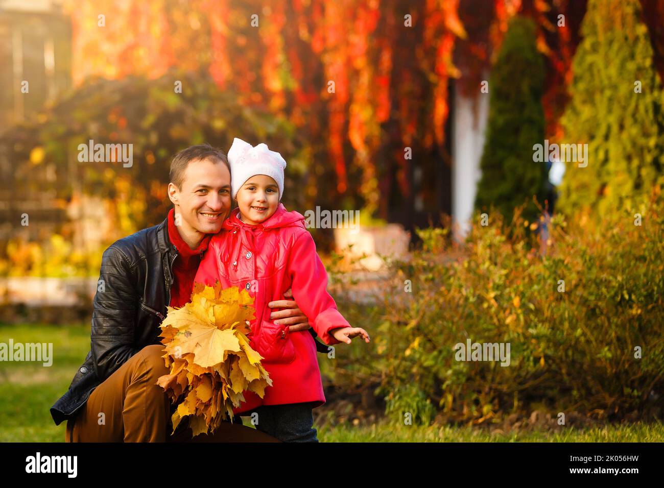 Father and daughter hug and laugh in the autumn park Stock Photo - Alamy