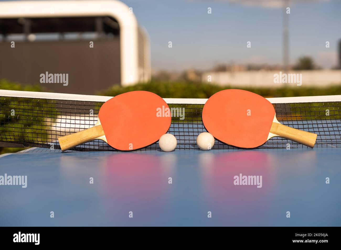 Ping pong table, rackets and balls in a sport hall Stock Photo - Alamy