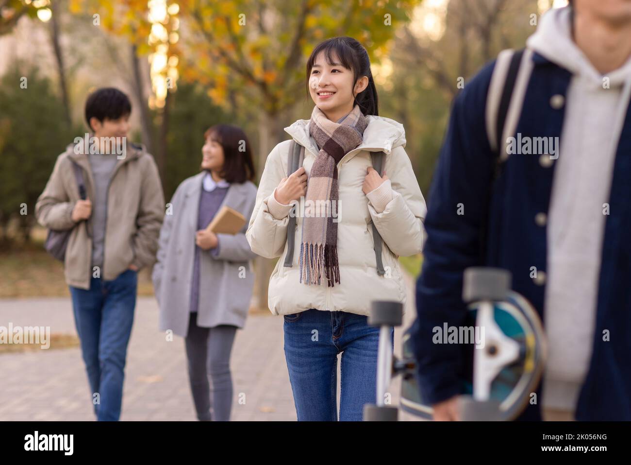 Happy Chinese college students walking on campus Stock Photo - Alamy