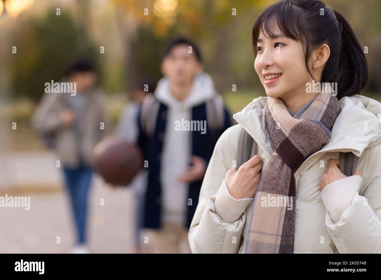 Happy Chinese college student walking on campus Stock Photo - Alamy