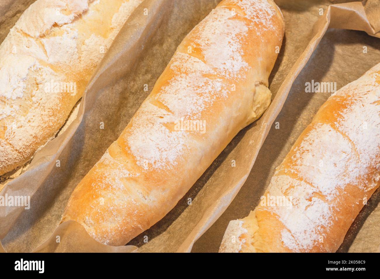 Three fresh loaves of bread on a baking sheet Stock Photo - Alamy