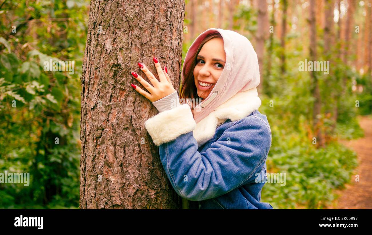 Young woman hugging tree in woodland hi-res stock photography and ...