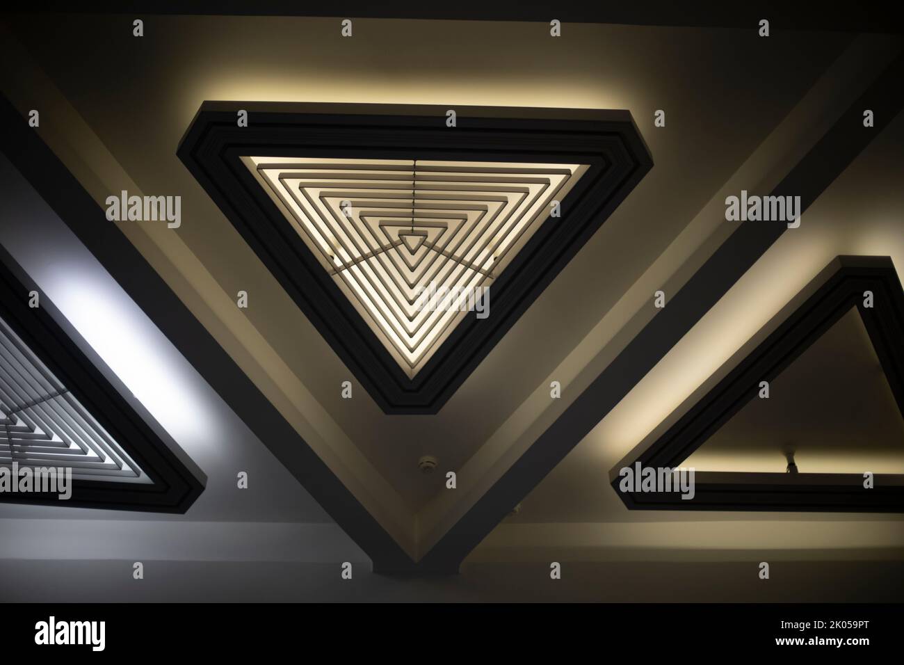 Triangular light source. Lamp in interior. Designer light. Architecture ...