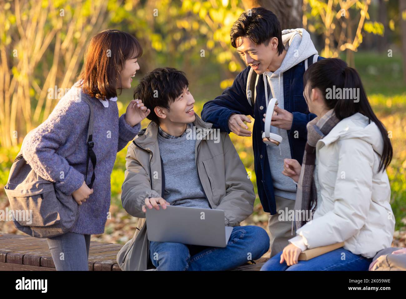 Happy Chinese college students using laptop on campus Stock Photo - Alamy