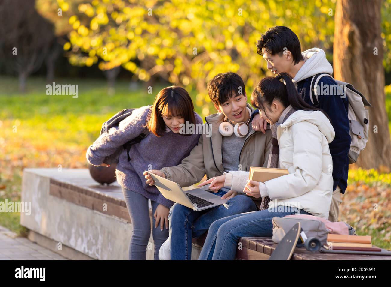 Happy Chinese college students using laptop on campus Stock Photo - Alamy