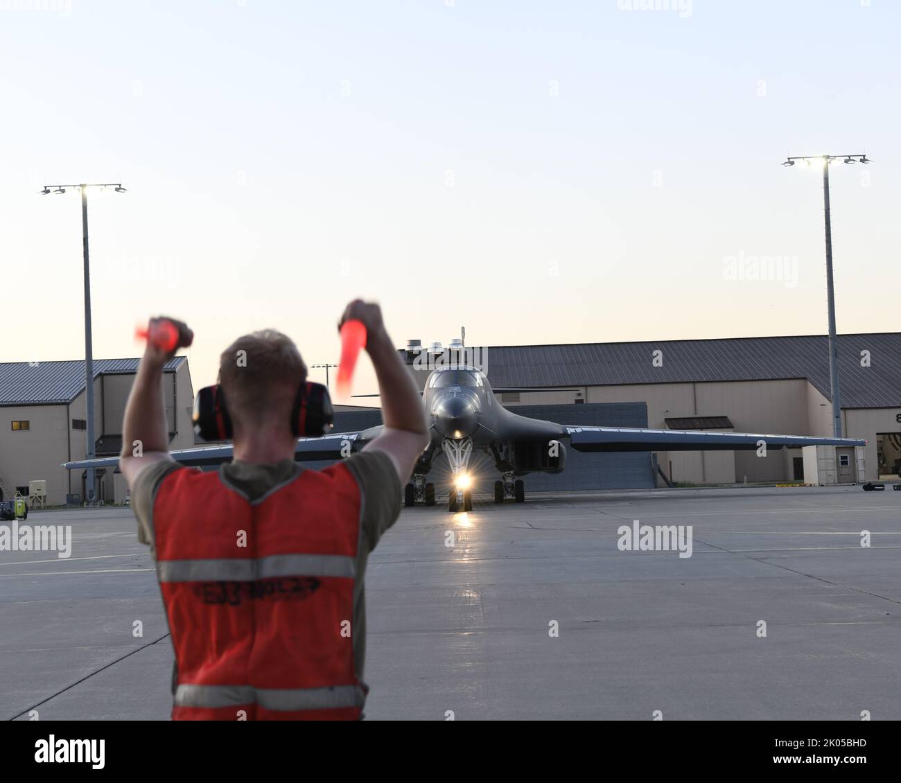 U.S. Air Force airmen directs a B-1B Lancer onto the runway during a ...