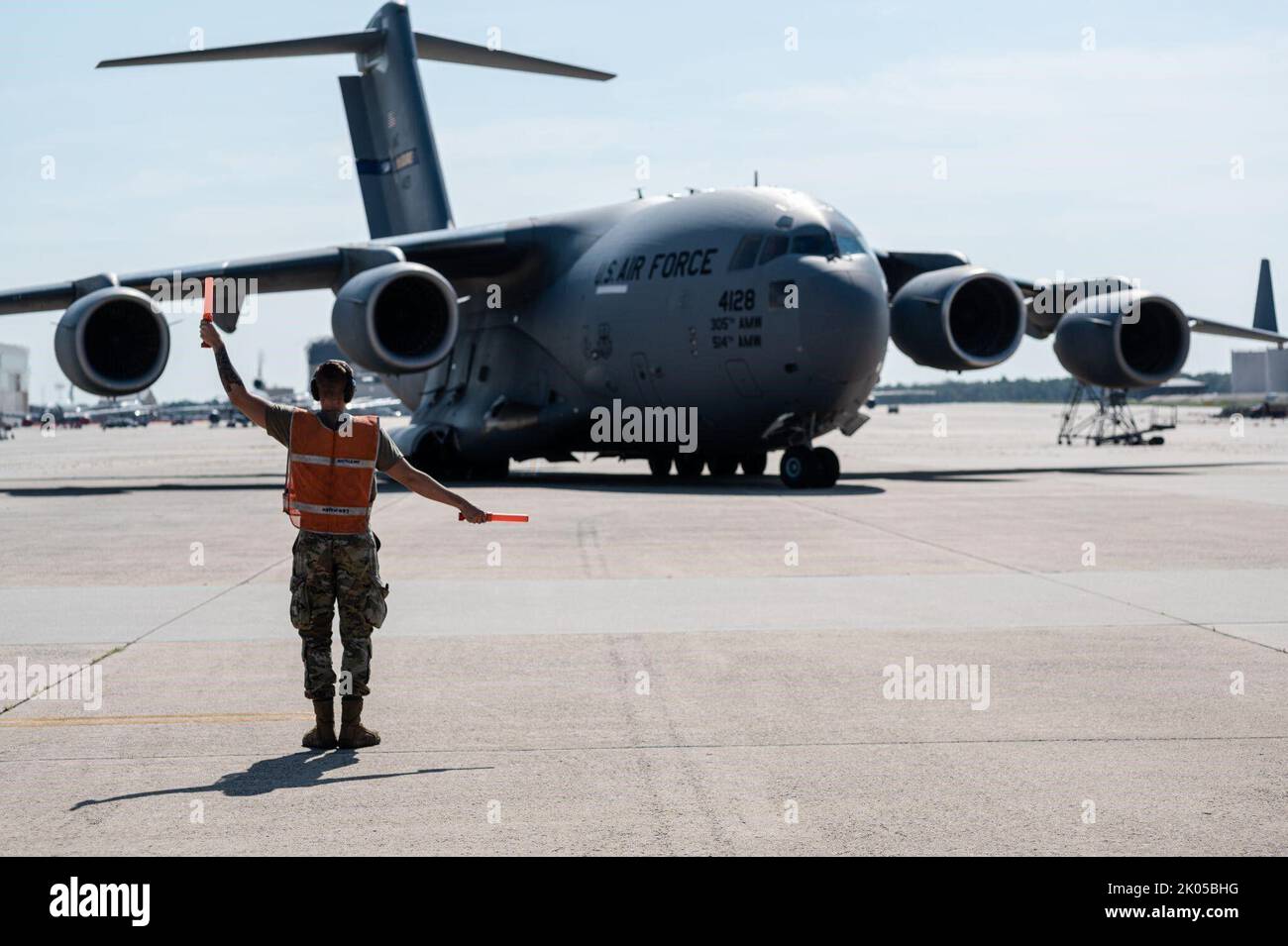 An Airman assigned to the 305th Aircraft Maintenance Squadron marshals ...