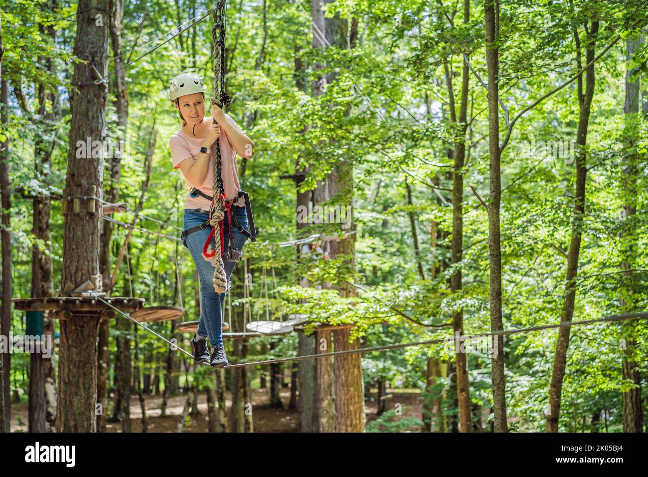 Happy women girl female gliding climbing in extreme road trolley ...
