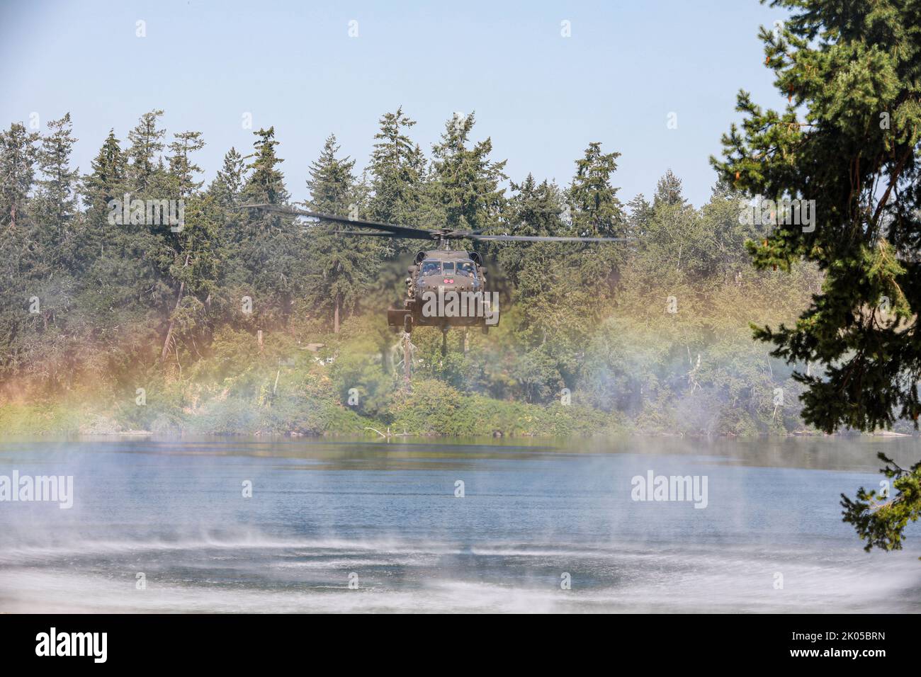 Soldiers from 1st Special Forces Group (Airborne), jump from a UH-60 ...