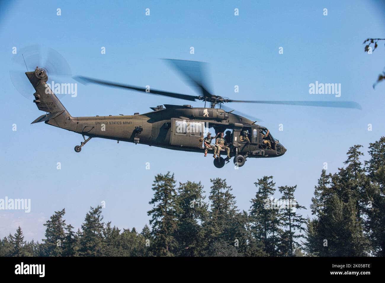 Soldiers from 1st Special Forces Group (Airborne), jump from a UH-60 ...