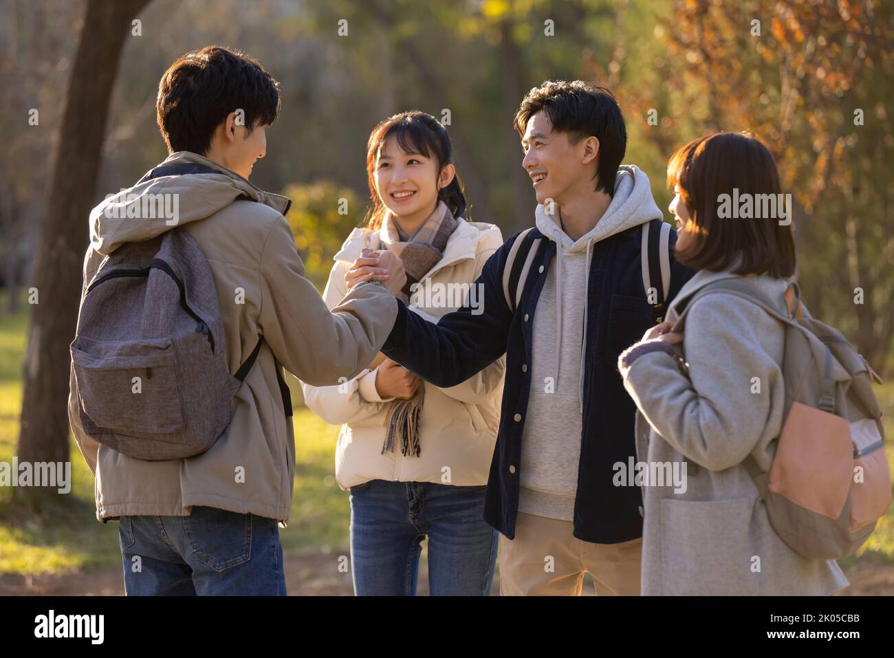 Happy Chinese college students talking on campus Stock Photo - Alamy
