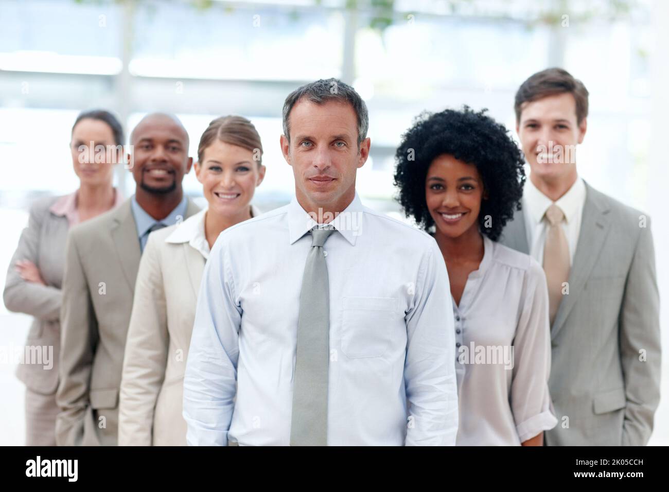 The team you need. Confident business team stand facing you ready to ...