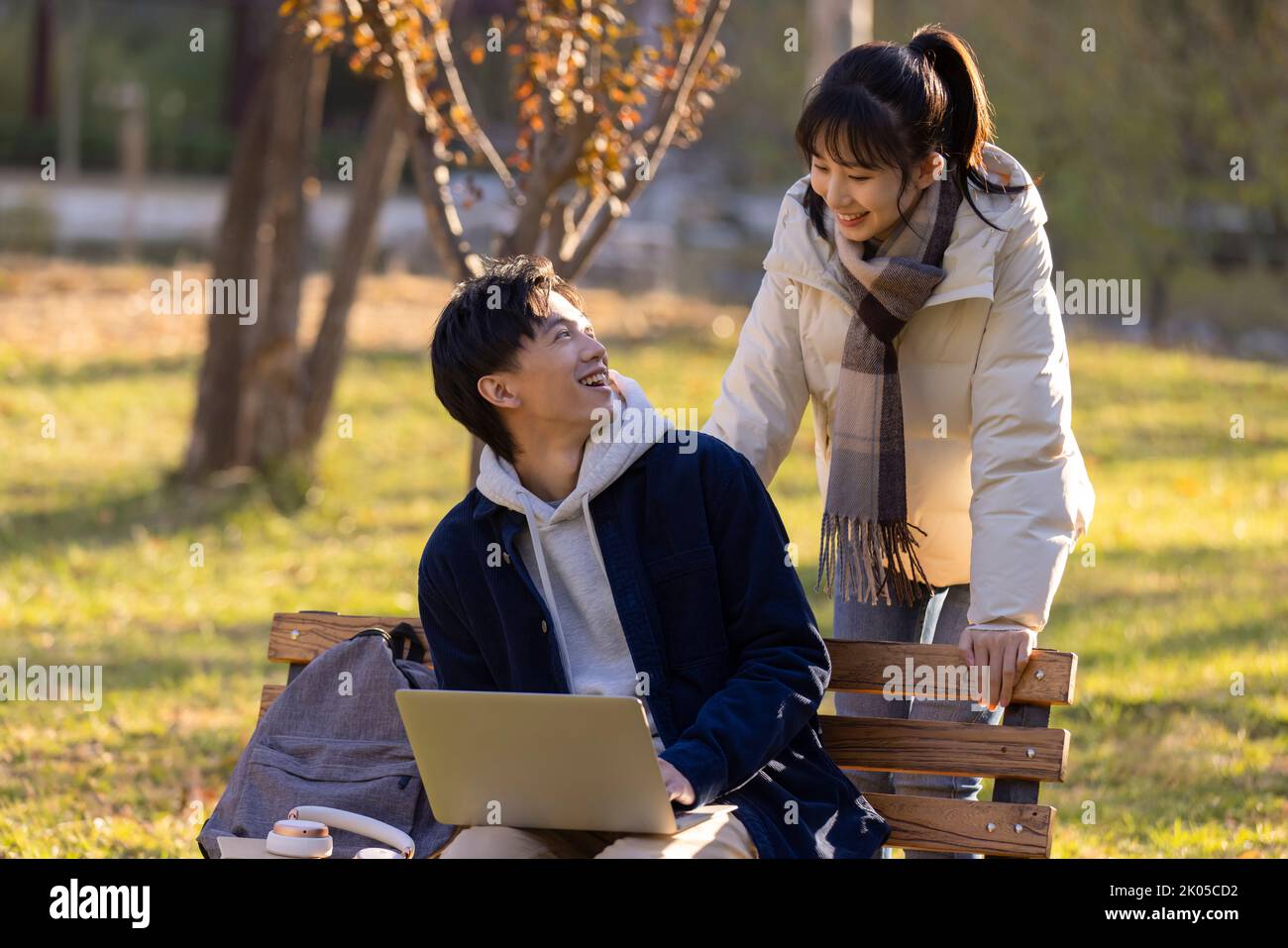 Happy Chinese college students using laptop on campus Stock Photo - Alamy