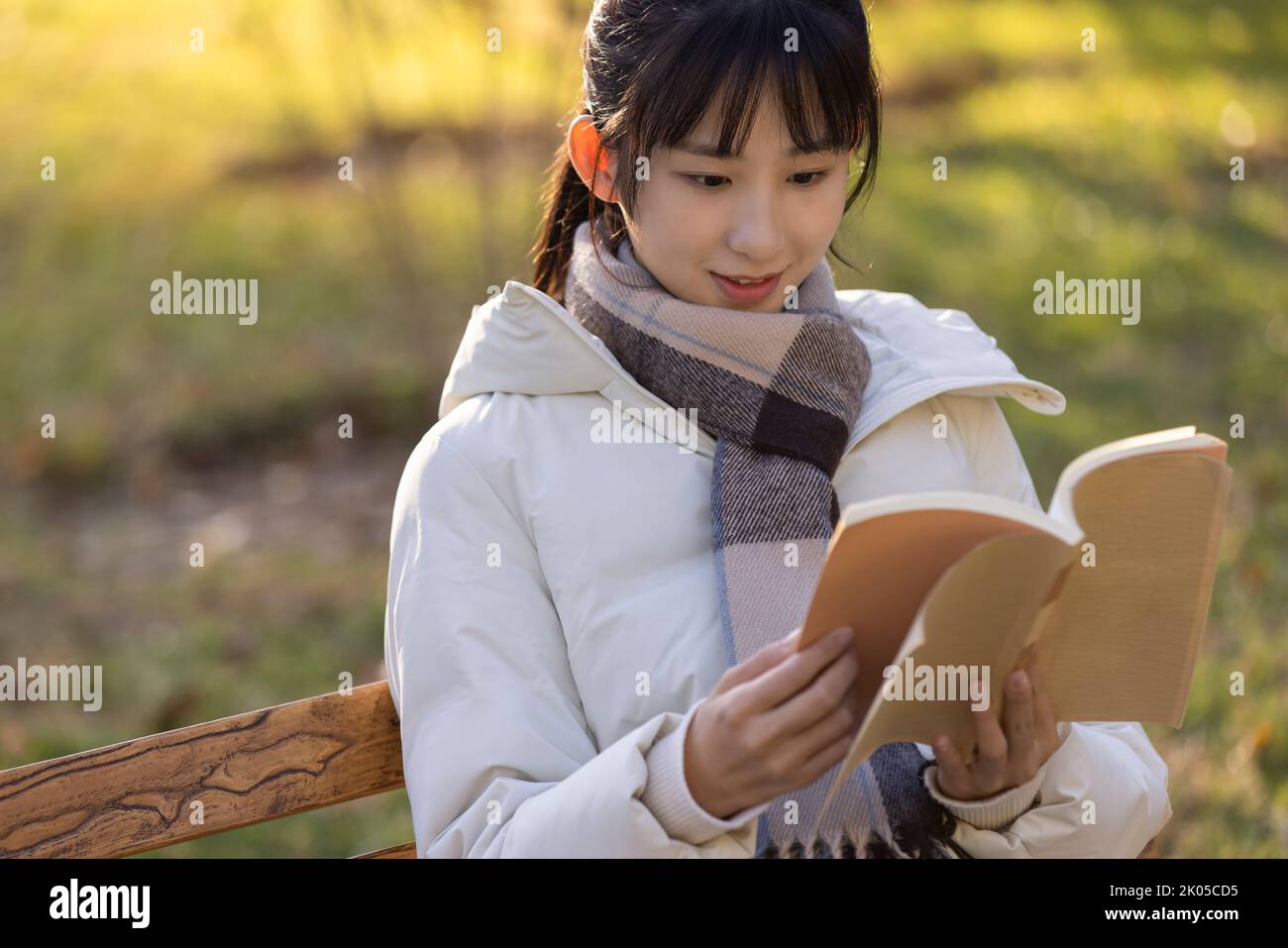 Happy Chinese college student reading on campus Stock Photo - Alamy