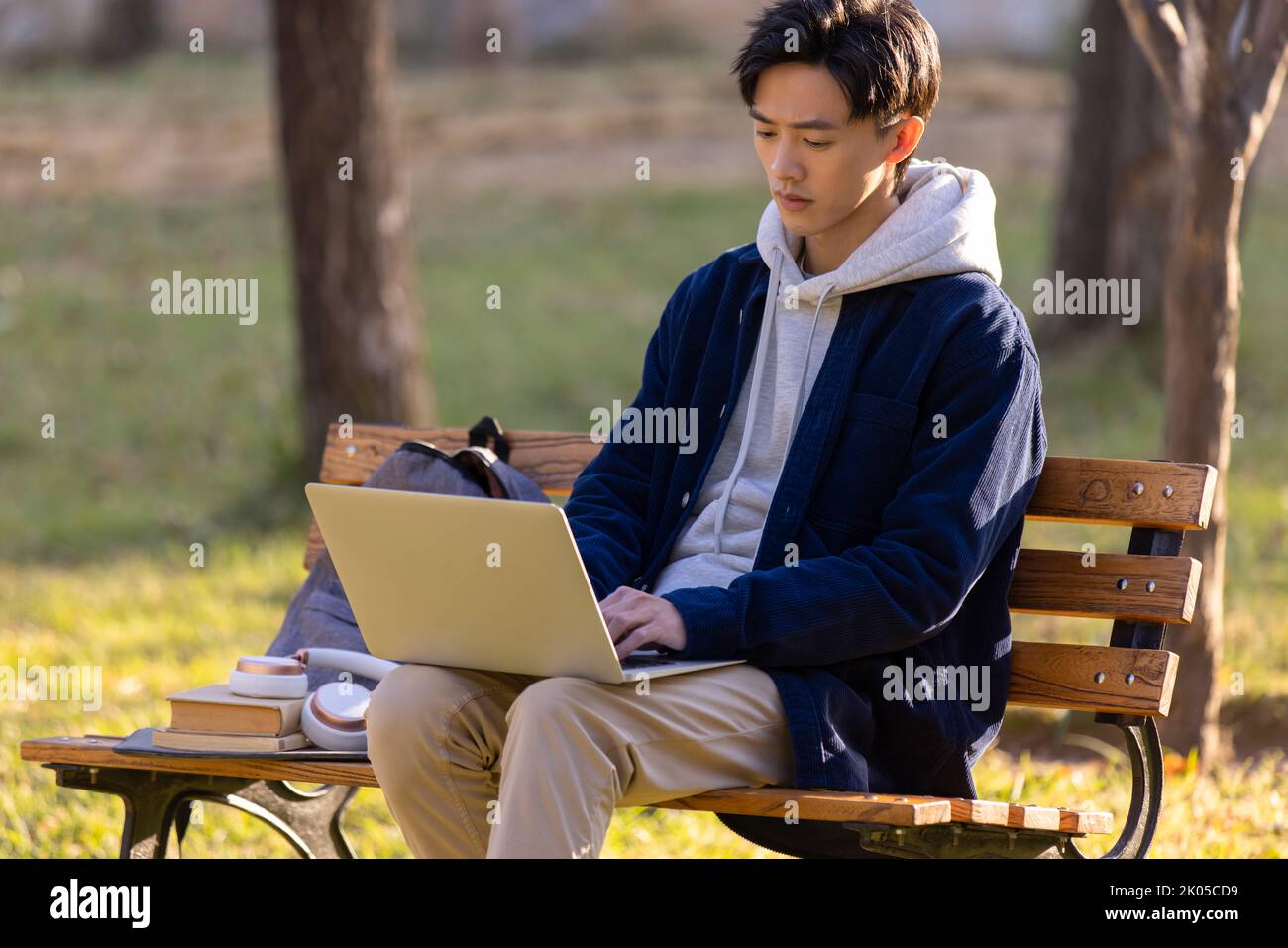 Happy Chinese college student using laptop on campus Stock Photo - Alamy