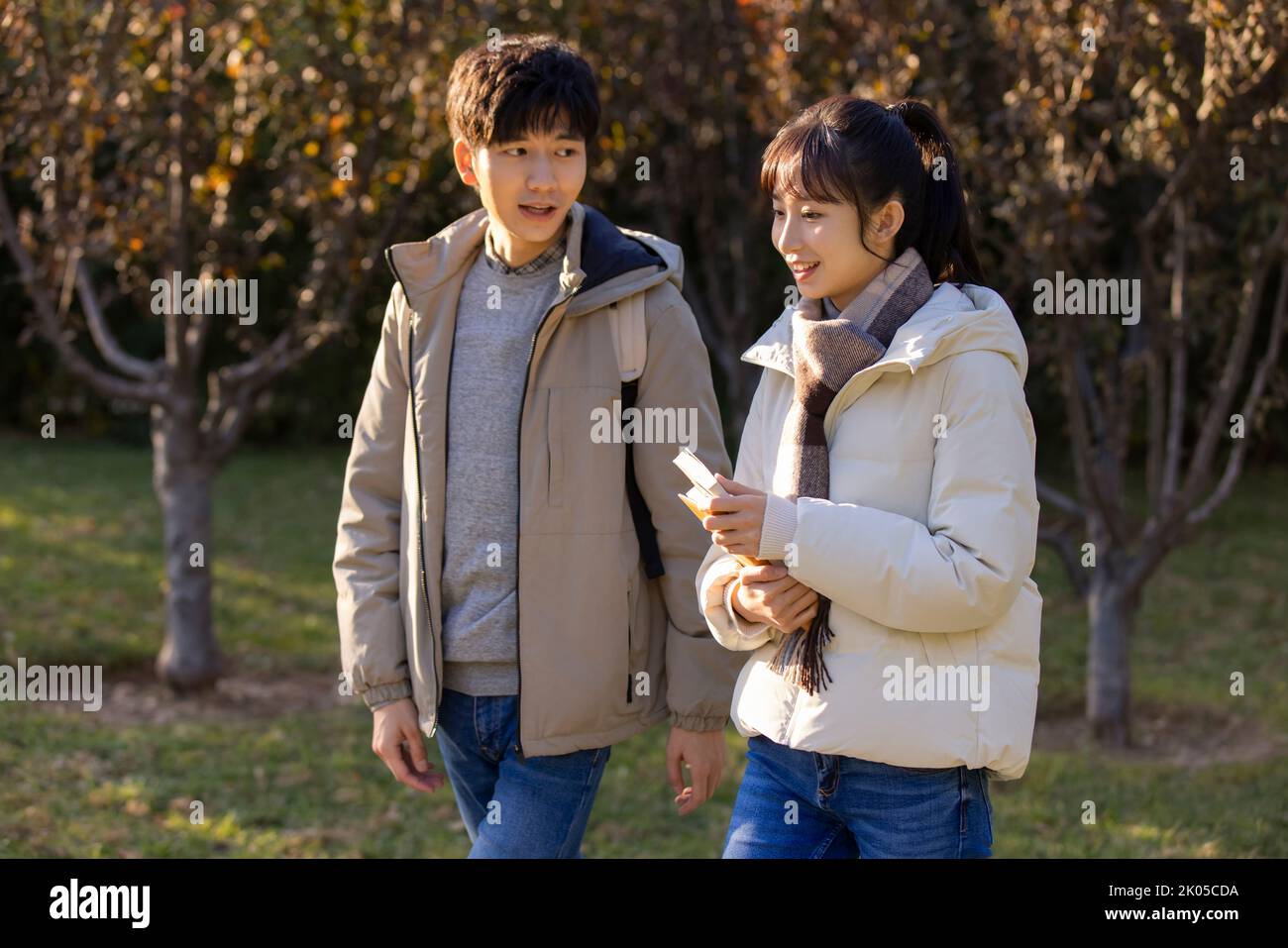 Happy Chinese college students walking on campus Stock Photo - Alamy