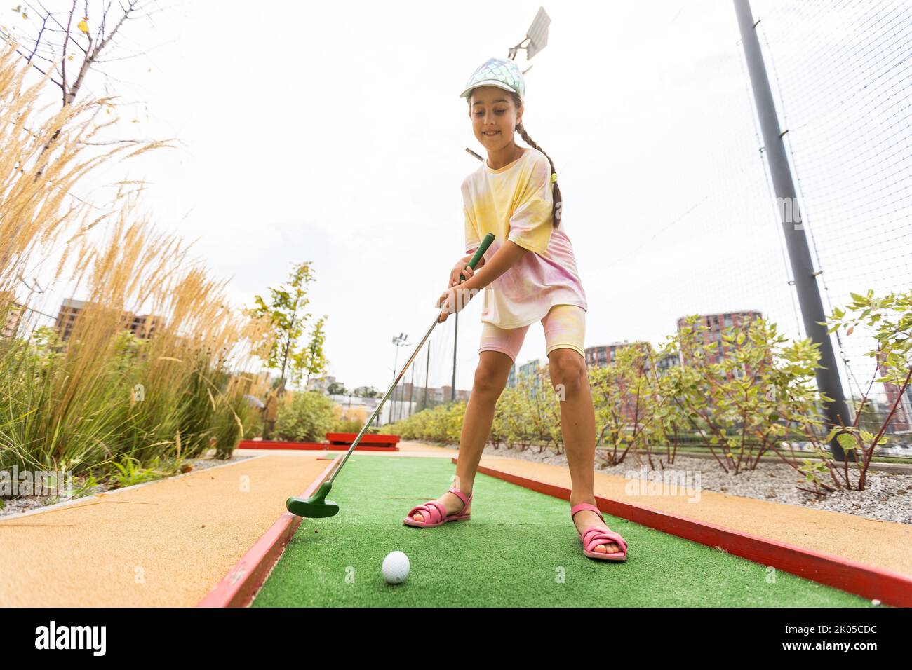 Beautiful little girl playing mini Golf Stock Photo - Alamy