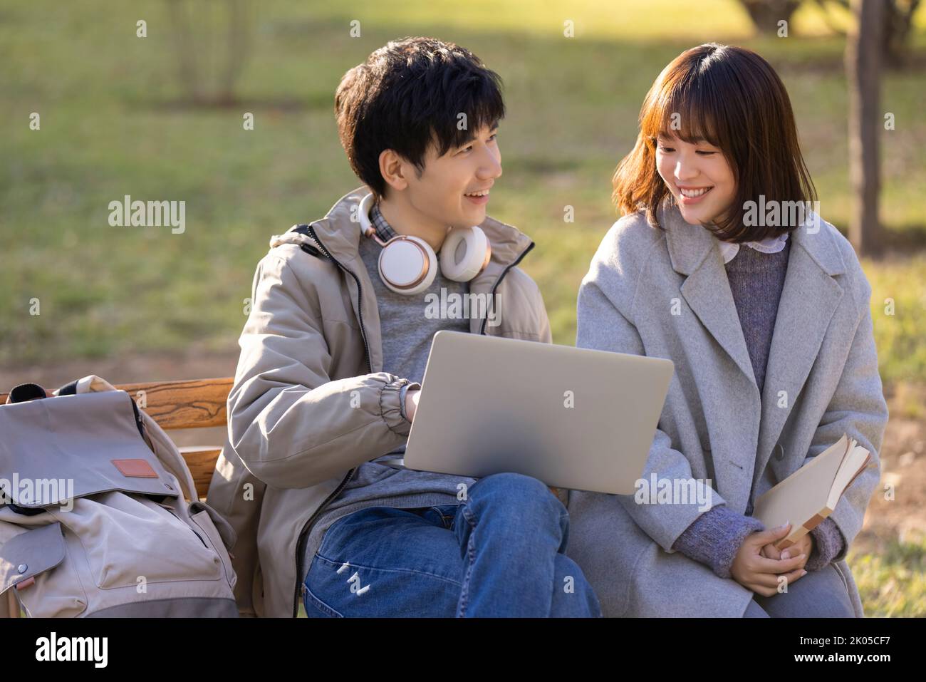 Happy Chinese college students using laptop on campus Stock Photo - Alamy