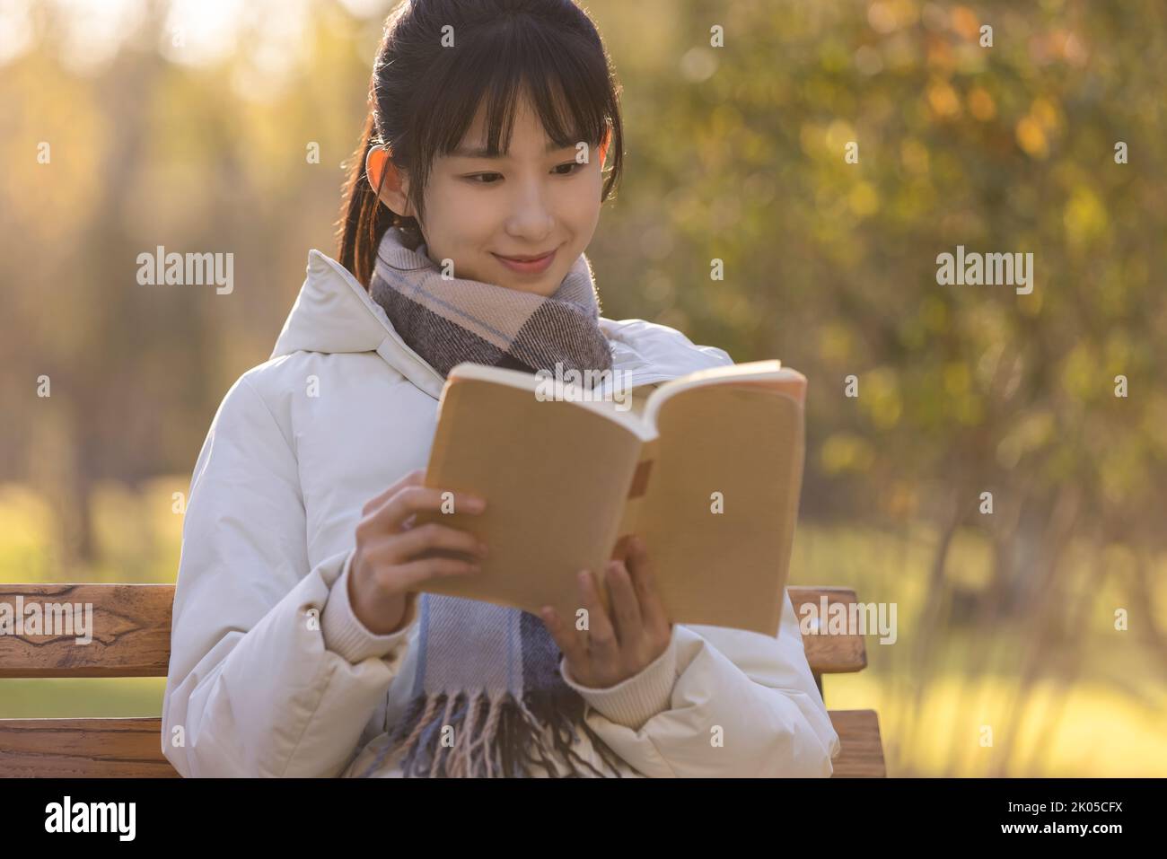 Happy Chinese college student reading on campus Stock Photo - Alamy