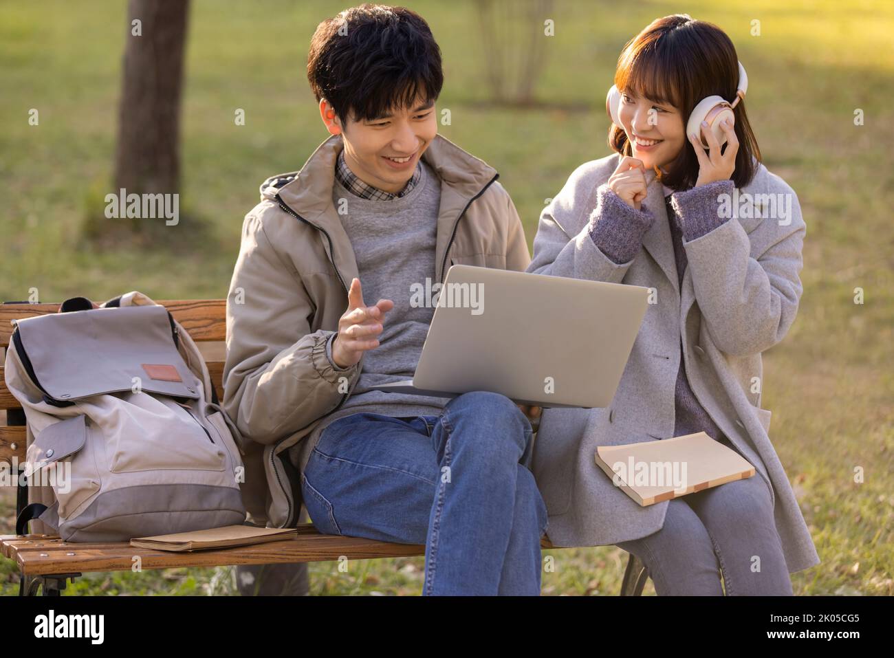 Happy Chinese college students using laptop on campus Stock Photo - Alamy