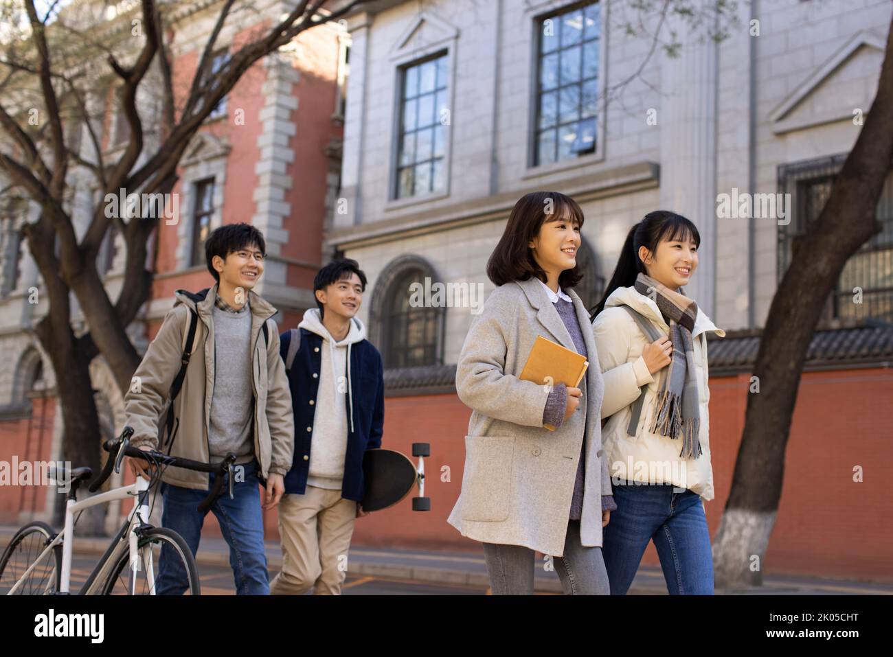 Happy Chinese college students walking on campus Stock Photo - Alamy