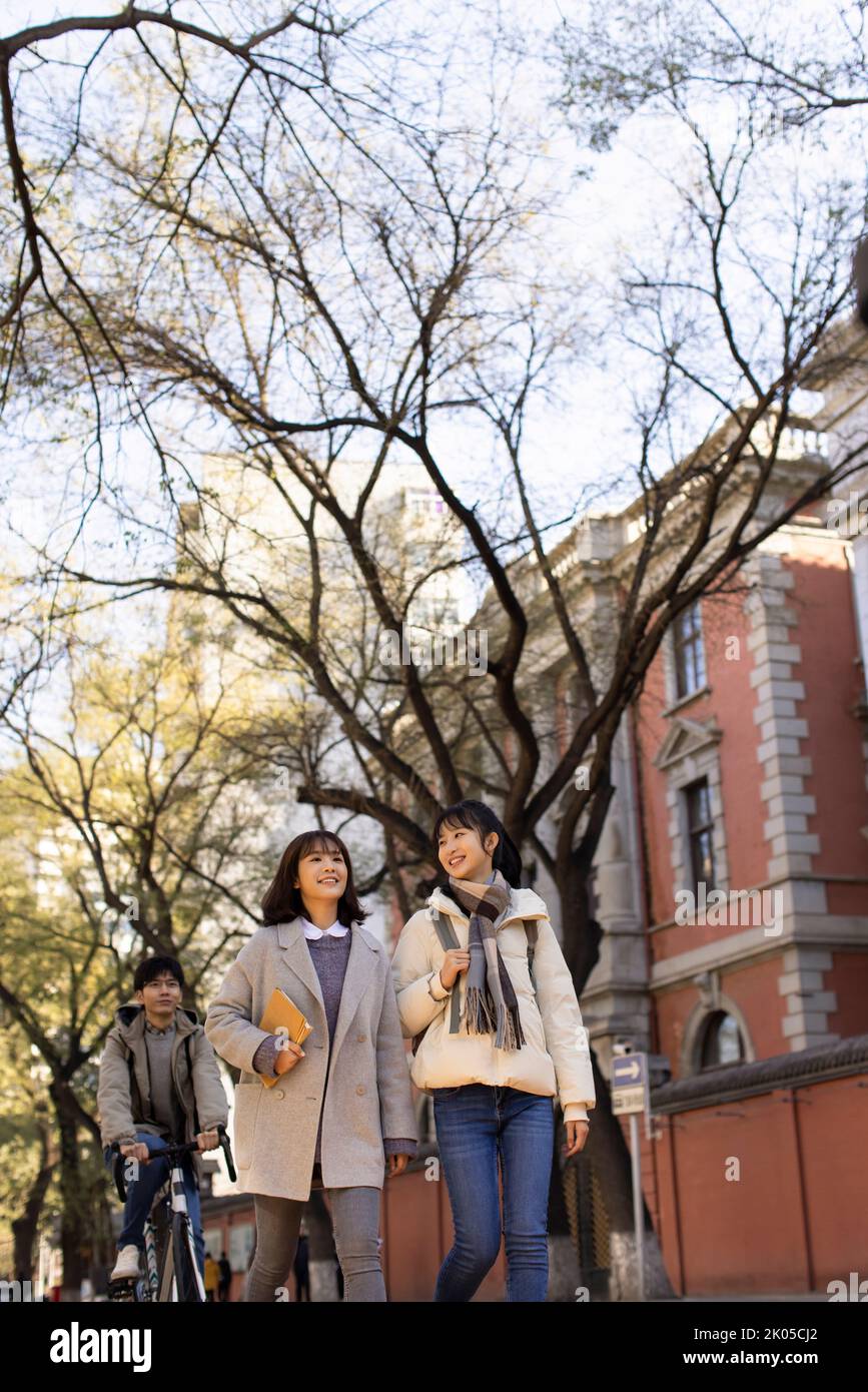 Happy Chinese college students walking on campus Stock Photo - Alamy