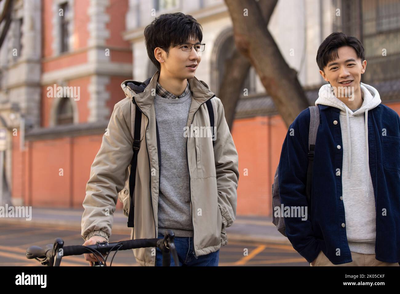 Happy Chinese college students walking on campus Stock Photo - Alamy