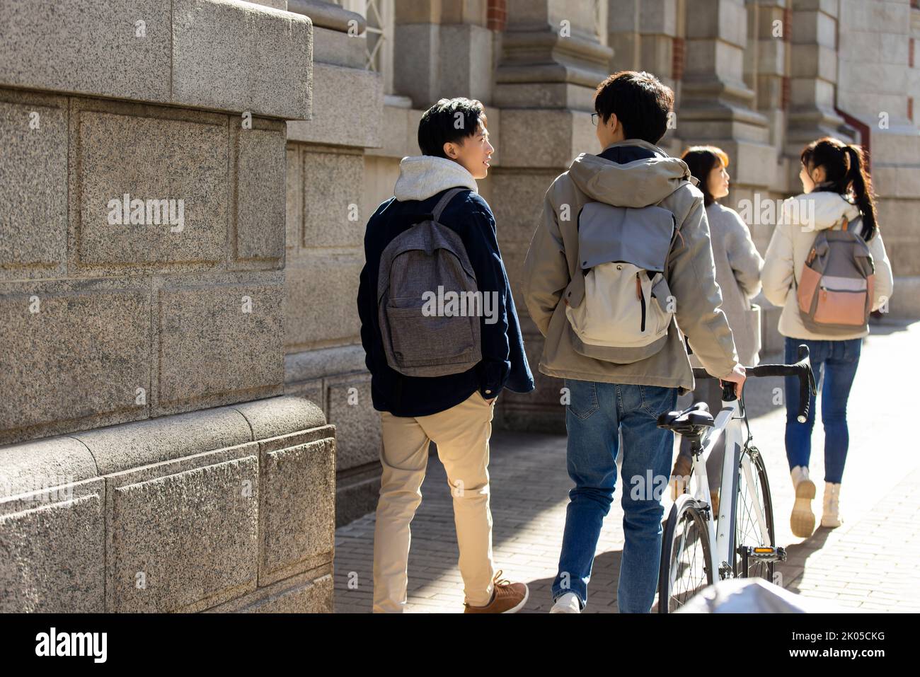 Happy Chinese college students walking on campus Stock Photo - Alamy