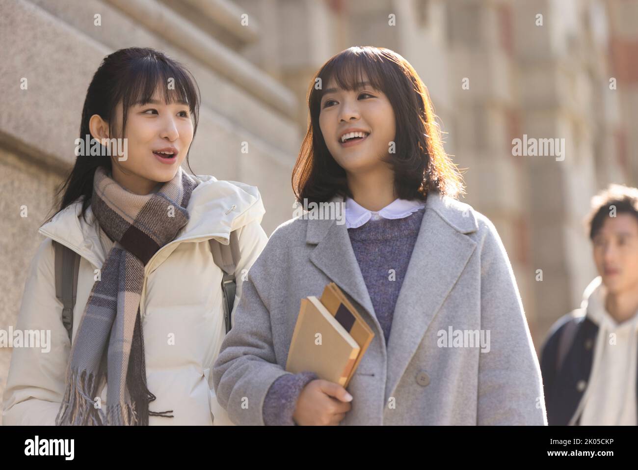 Happy Chinese college students walking on campus Stock Photo - Alamy