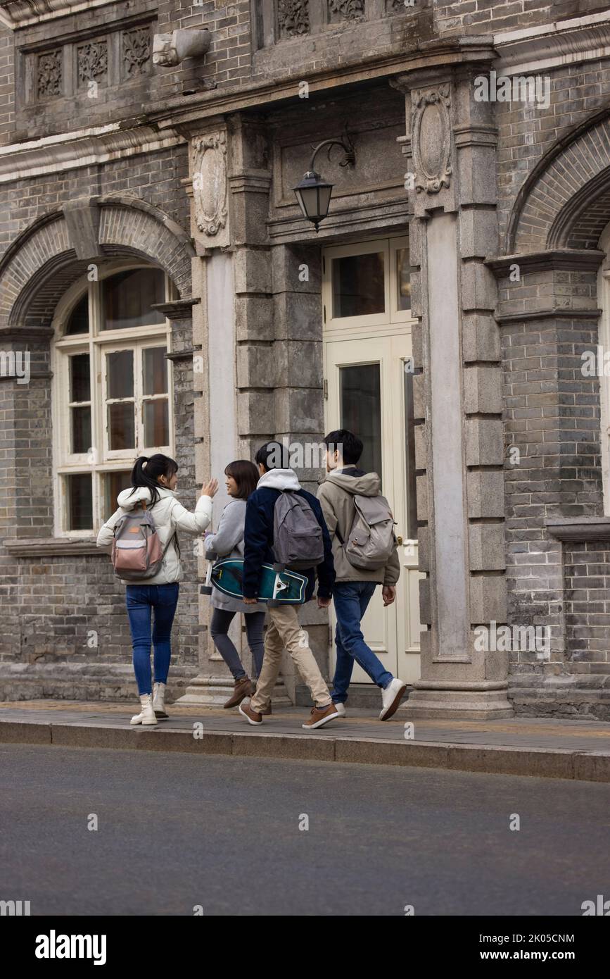 Happy Chinese college students walking on campus Stock Photo - Alamy