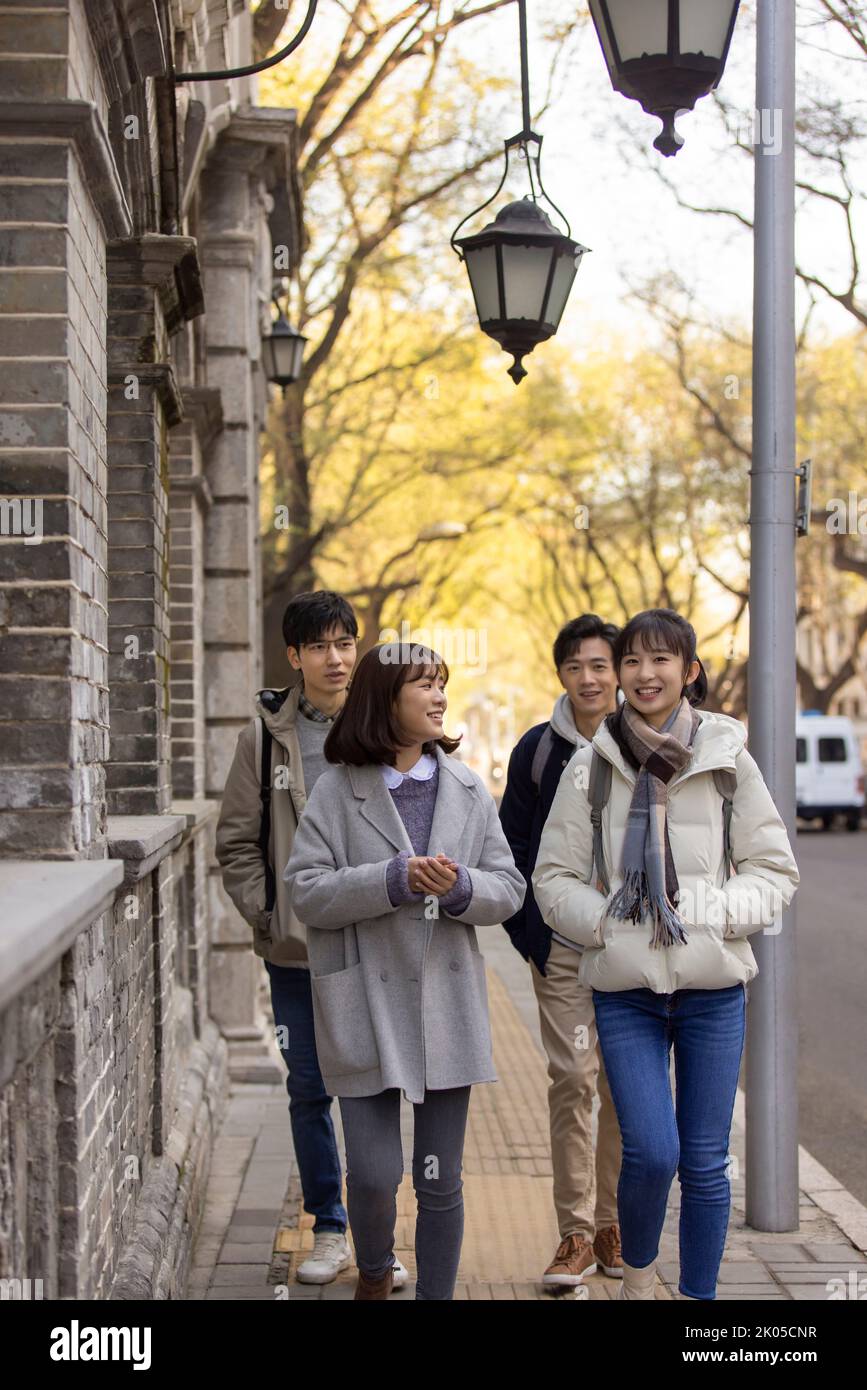 Happy Chinese college students walking on campus Stock Photo - Alamy