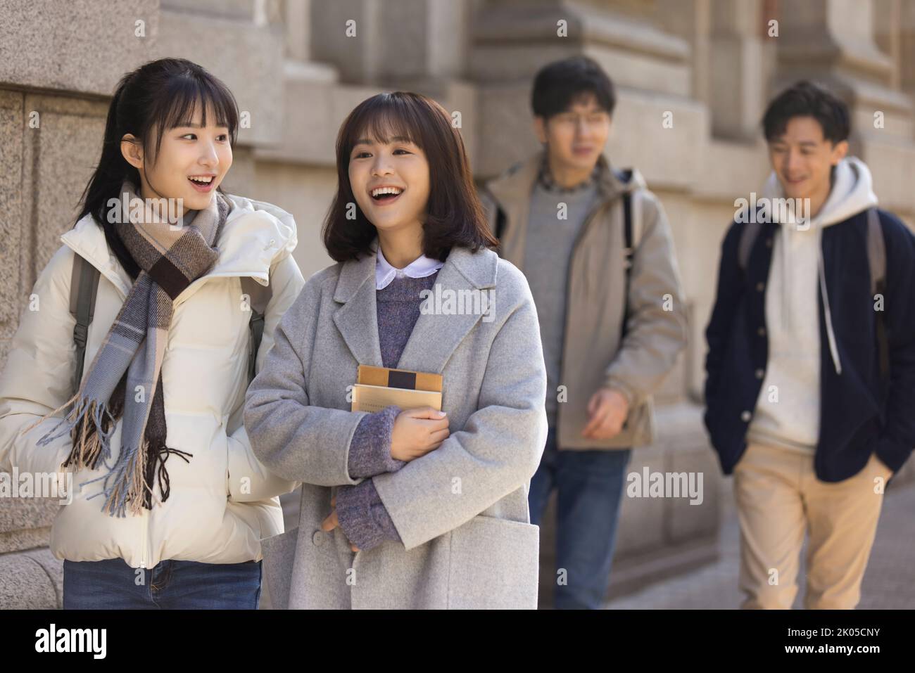 Happy Chinese college students walking on campus Stock Photo - Alamy